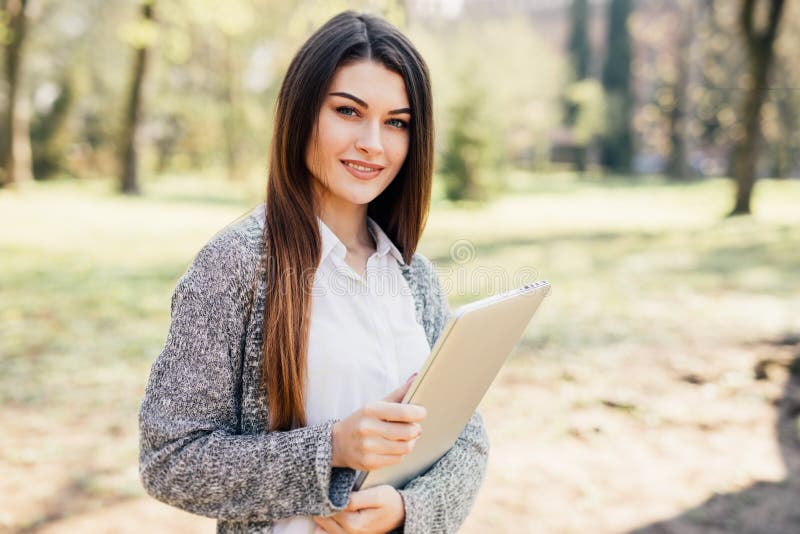 Young Woman Walking in the Park with Laptop in Hands Stock Photo ...