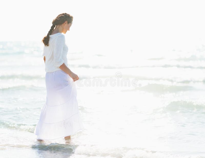 Young Woman Walking into Sea Stock Photo - Image of enjoying, beautiful ...