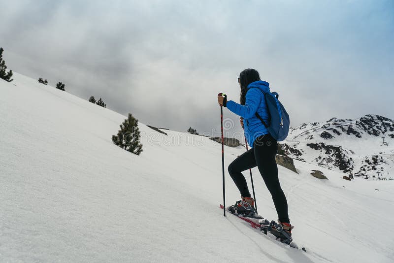 Young Woman Walking with Snow Rackets in High Mountain Stock Photo ...