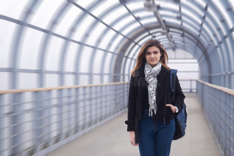 Young Woman Walks Quickly through the Covered Walkway Stock Photo ...