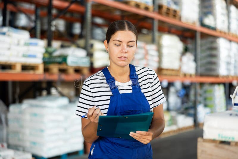 Young Woman Warehouse Worker Checking Documents Stock Image - Image of ...