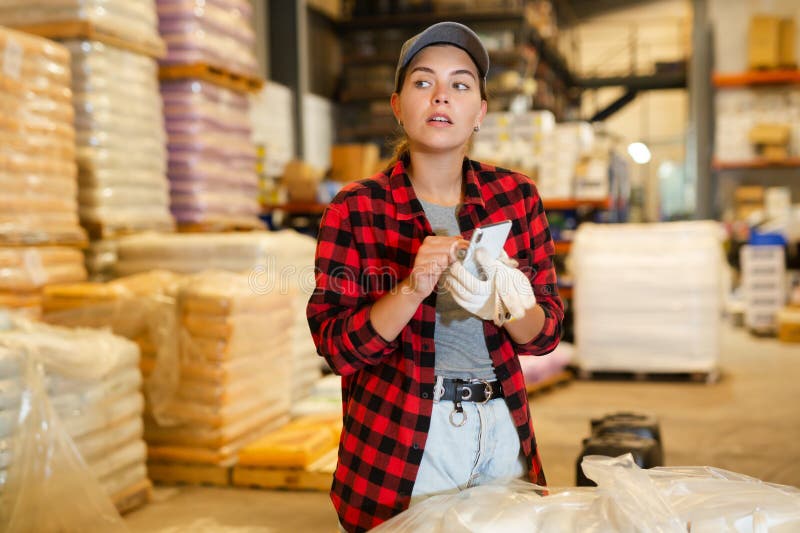 Young Woman Warehouse Worker Using Smartphone in Her Work Stock Photo ...