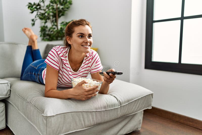 Young Woman Watching Movie Lying on Sofa at Home Stock Image - Image of ...