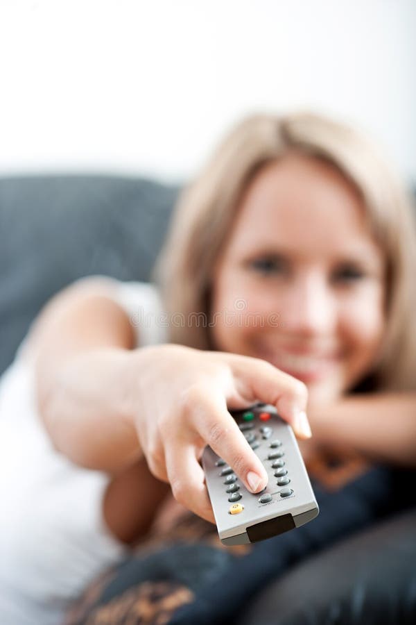 Young Woman Watching Television with a Remote Stock Image - Image of ...