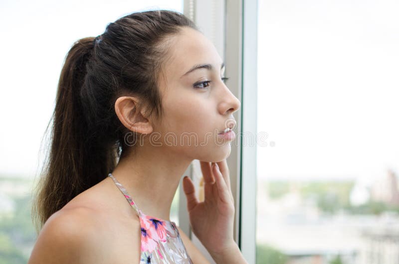Young Woman Watching through a Window Stock Image - Image of beautiful ...