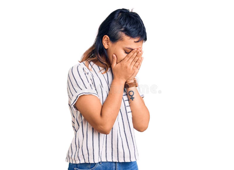 Young Woman Wearing Casual Clothes With Sad Expression Covering Face