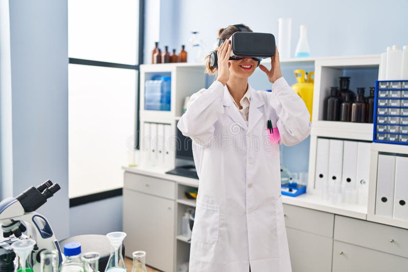 Young Woman Wearing Scientist Uniform Using Virtual Reality Goggles at ...