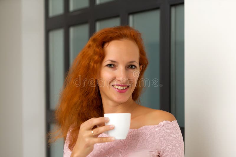 Young Woman by the Window with a Cup of Tea or Coffee. Stock Photo ...