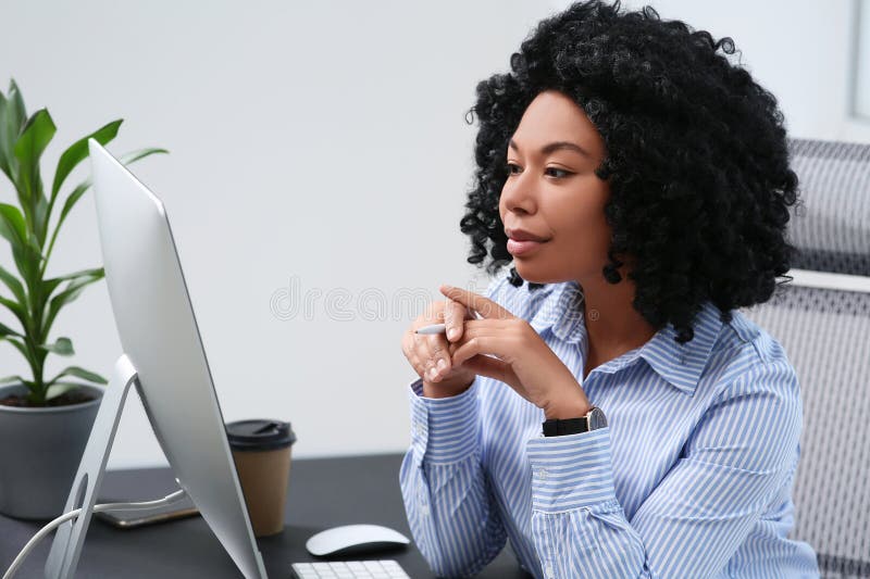 Young Woman Working on Computer at Table in Office Stock Photo - Image ...