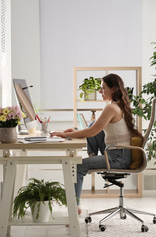Young Woman Working on Computer at Table in Room Stock Image - Image of ...