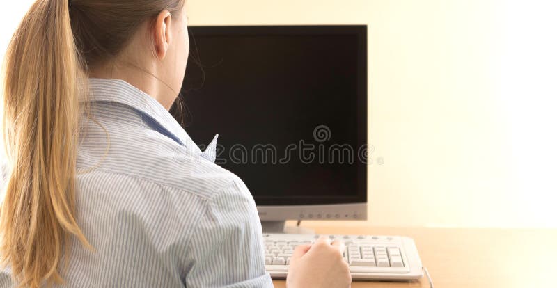 Young Woman Working on a Desktop Computer at Her Desk in the Office ...