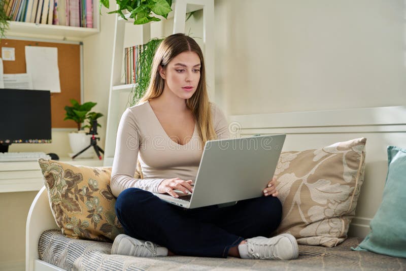 Young Woman Working at Home, Sitting on Couch Using Laptop Stock Image ...
