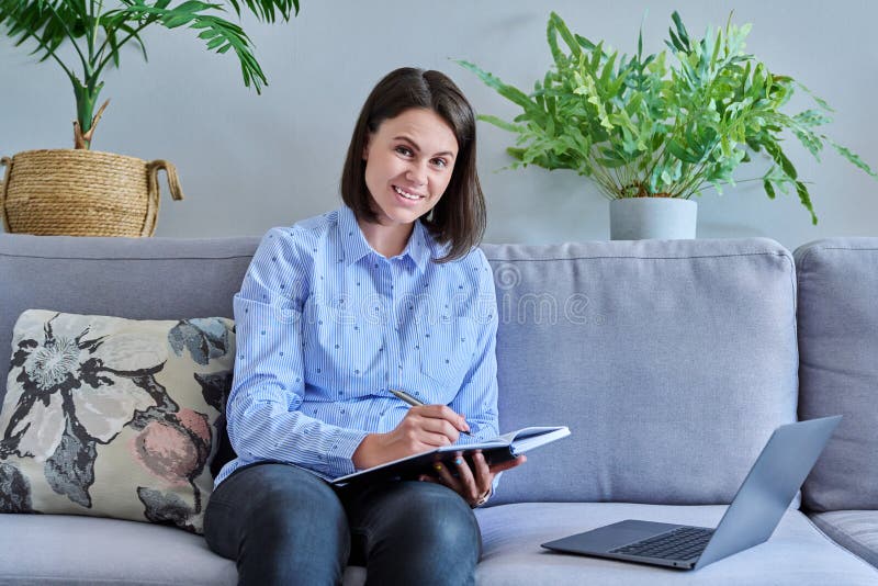 Young Woman Working from Home Using Laptop Making Notes Stock Image ...