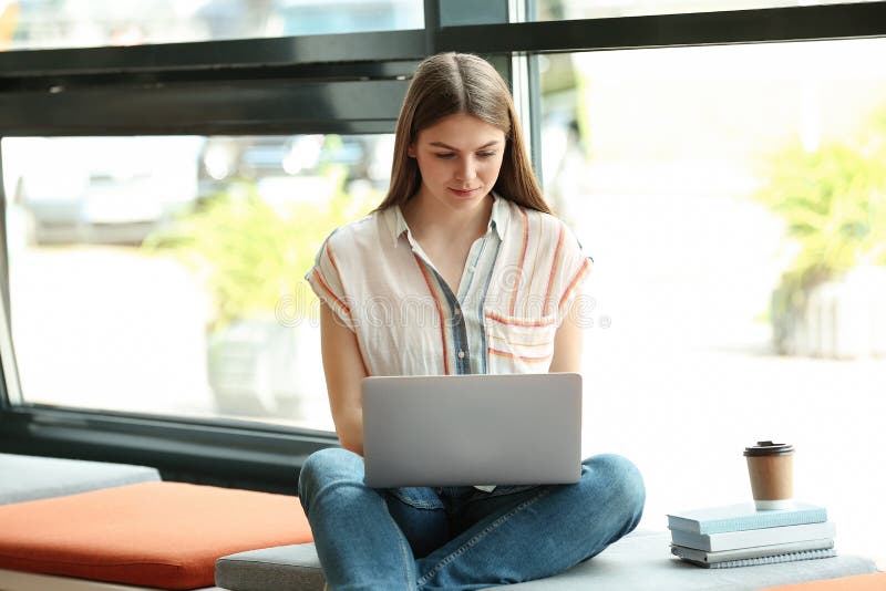 Young Woman Working on Laptop Near Window Stock Image - Image of bench ...