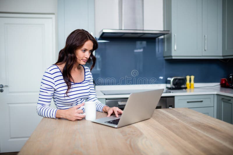 Young Woman Working on Laptop while Sitting at Table Stock Image ...