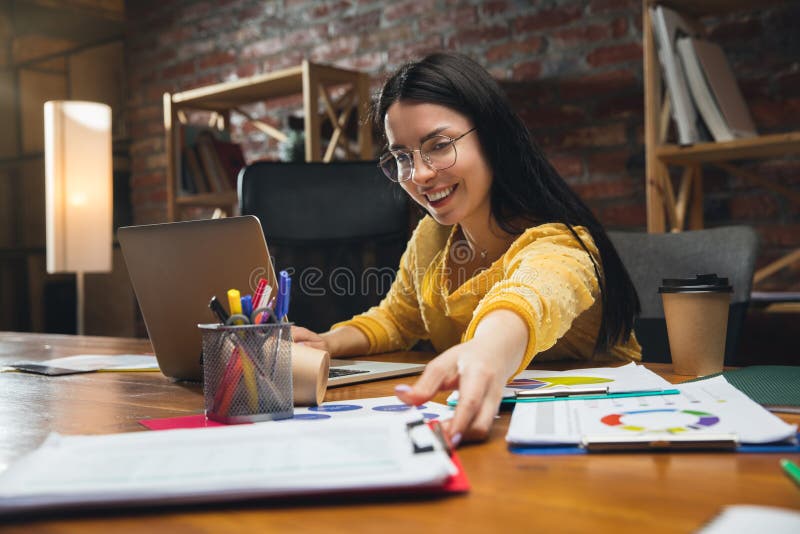 Young Woman Working in Modern Office Using Devices and Gadgets. Making ...