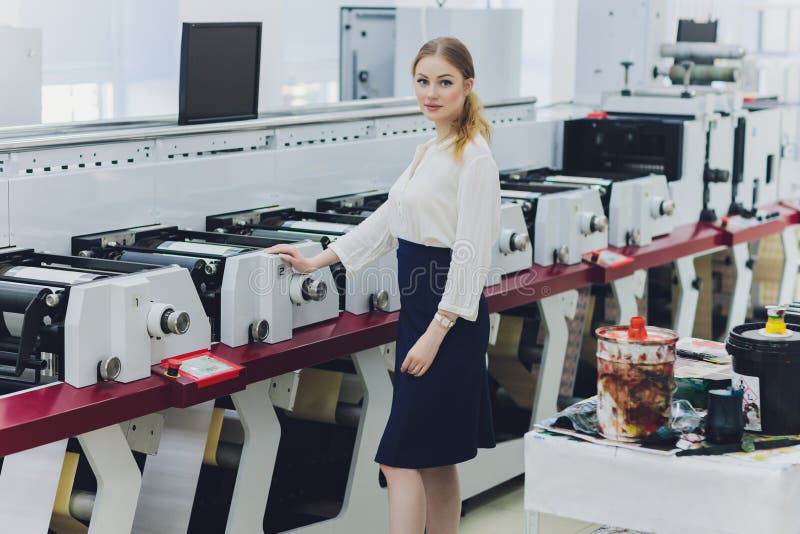 Young Woman Working in Printing Factory. Printing Press. Stock Photo ...