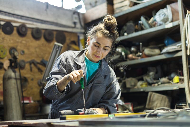 Young Woman Fixing Tool at Work Stock Photo - Image of occupation ...