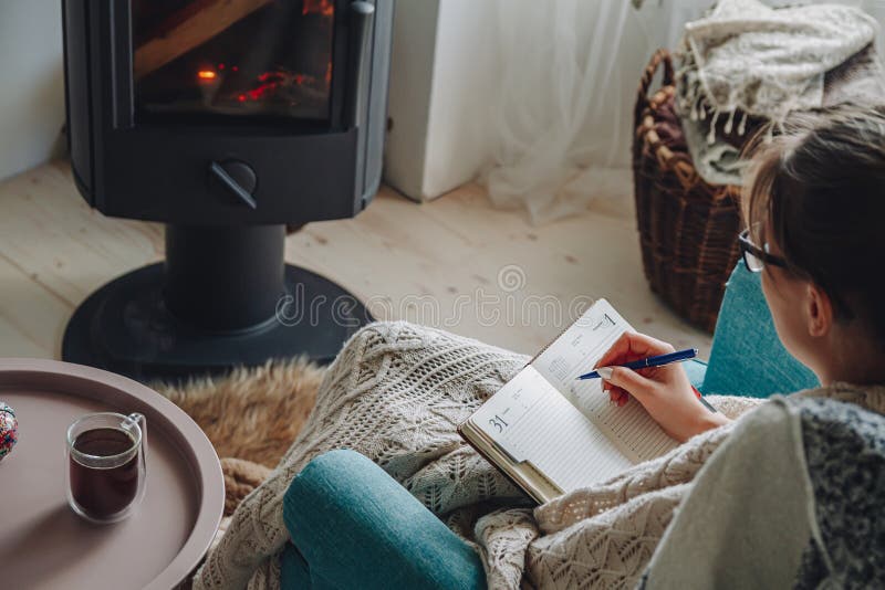 Young Woman Write in Notebook Sitting in Armchair by Fireplace Stock ...