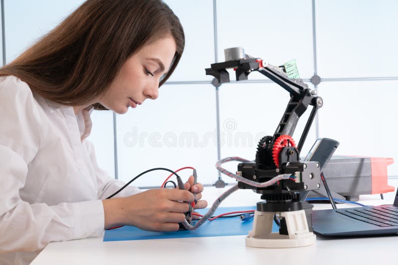 A Young Woman Writes an Algorithm for the Robot Arm. Science Research ...