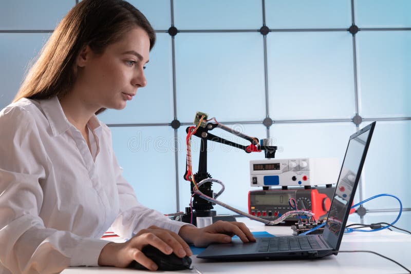 A Young Woman Writes an Algorithm for the Robot Arm. Science Research ...