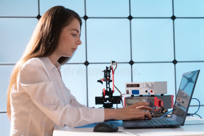 A Young Woman Writes an Algorithm for the Robot Arm. Science Research ...