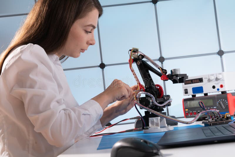 A Young Woman Writes an Algorithm for the Robot Arm. Science Research ...