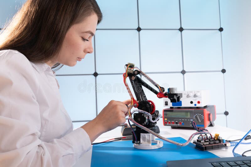 A Young Woman Writes an Algorithm for the Robot Arm. Science Research ...