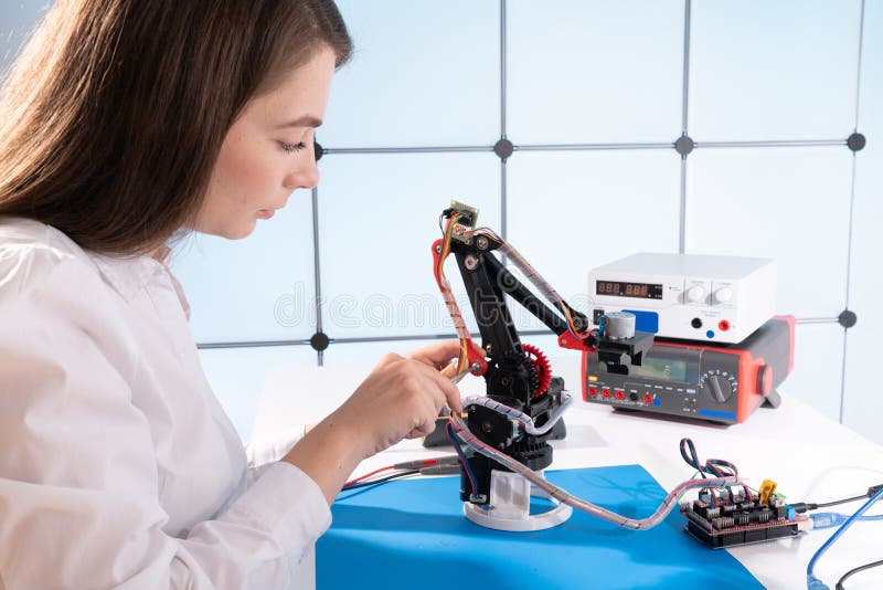 A Young Woman Writes an Algorithm for the Robot Arm. Science Research ...