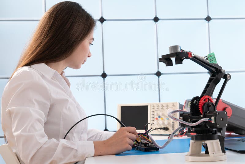 A Young Woman Writes an Algorithm for the Robot Arm. Science Research ...