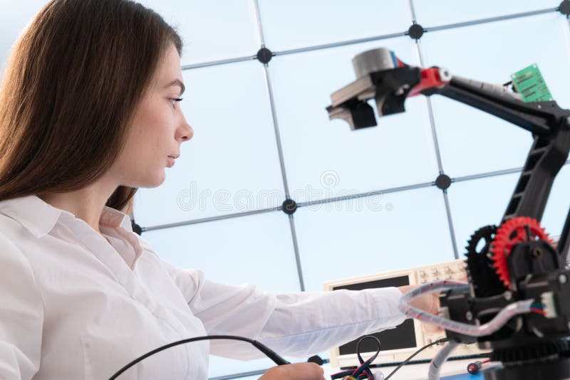 A Young Woman Writes An Algorithm For The Robot Arm Science Research Laboratory For Robotic Arm