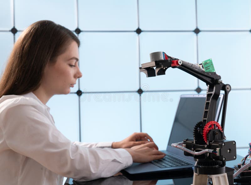 A Young Woman Writes an Algorithm for the Robot Arm. Science Research ...