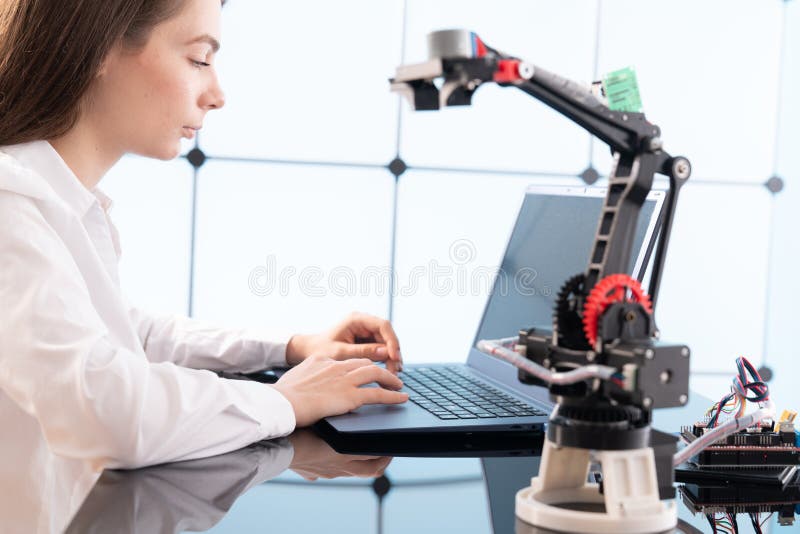 A Young Woman Writes an Algorithm for the Robot Arm. Science Research ...