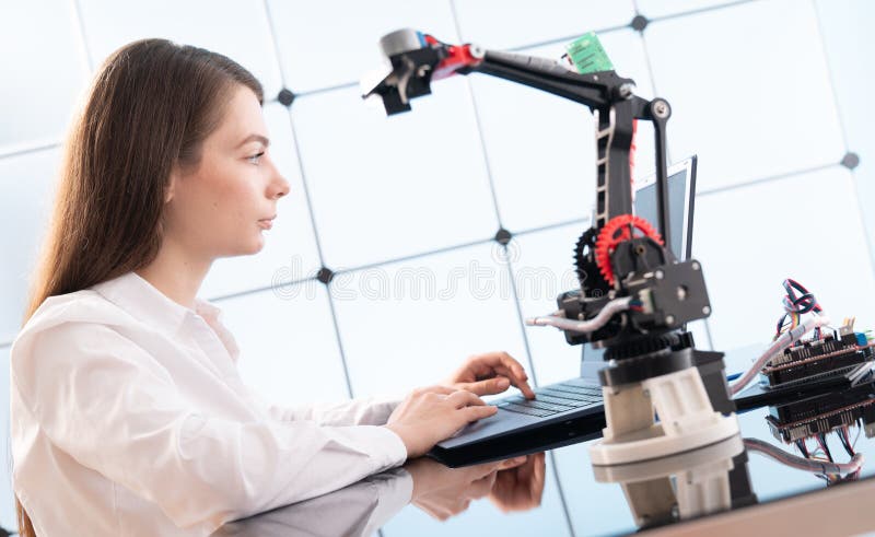 A Young Woman Writes an Algorithm for the Robot Arm. Science Research ...