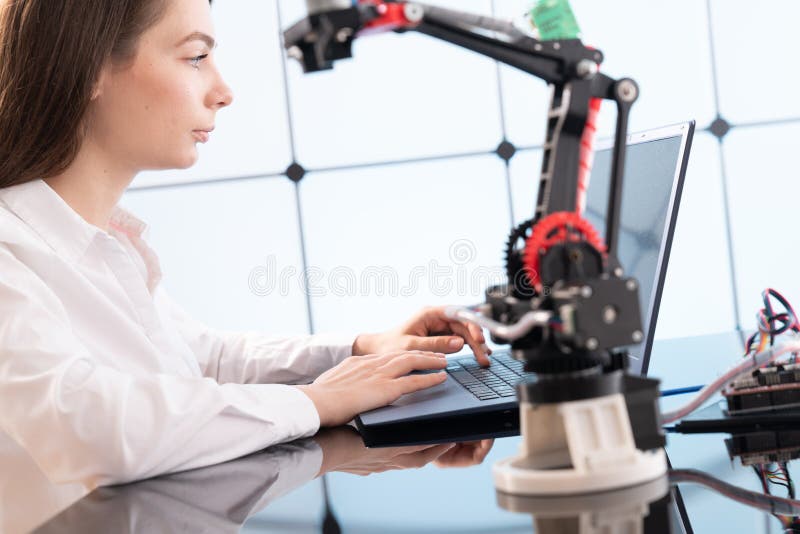 A Young Woman Writes an Algorithm for the Robot Arm. Science Research ...