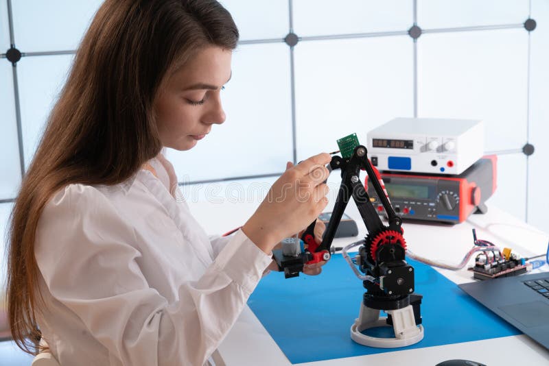 A Young Woman Writes an Algorithm for the Robot Arm. Science Research ...
