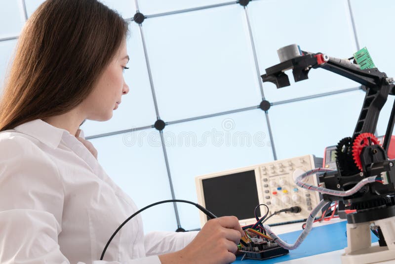 A Young Woman Writes an Algorithm for the Robot Arm. Science Research ...
