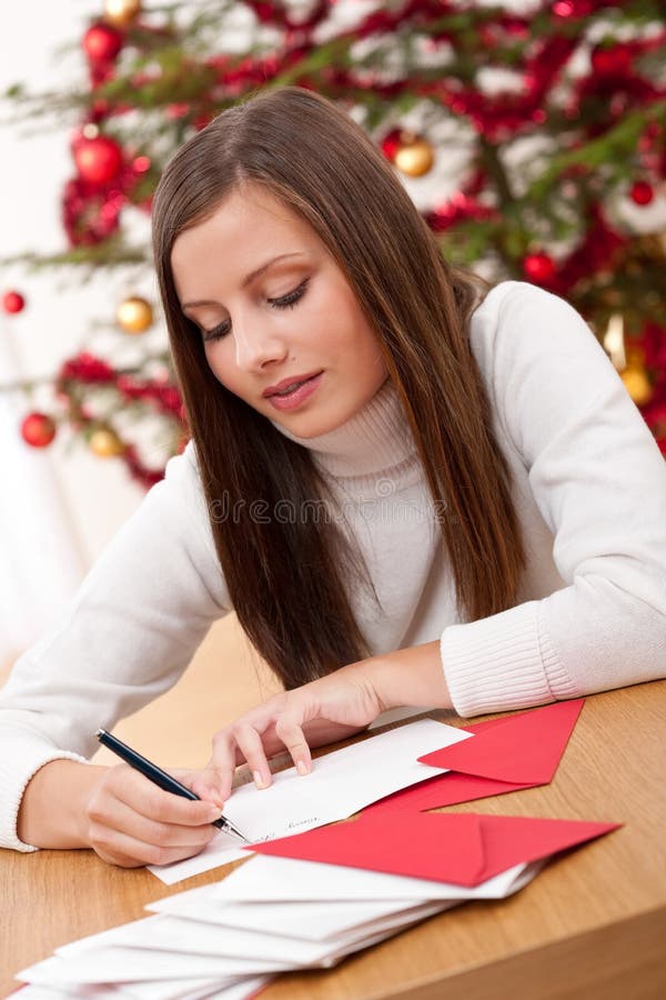 Young Woman Writing Christmas Card Stock Image - Image of brunette ...