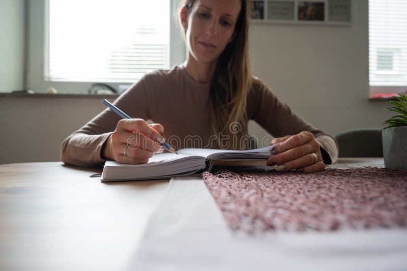 Young Woman Writing in Notebook Stock Photo - Image of writing, working ...