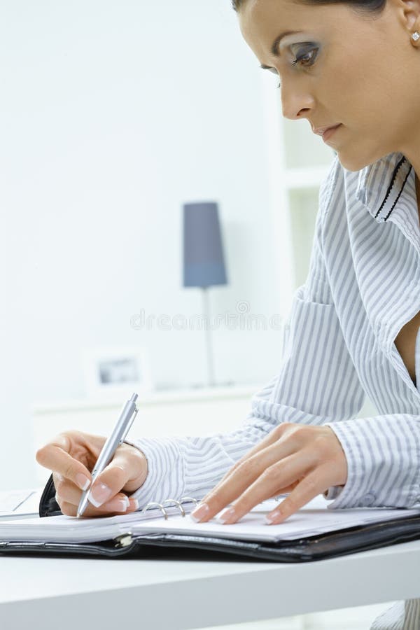 Woman writing at desk stock image. Image of holding, detail - 9886723
