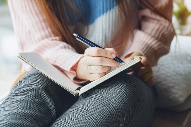 Girl Writing Notes on Notebook with Pen Sitting in Comfy Armchair ...