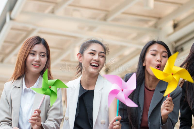 Young Womans Playing with Paper Windmills or Wind Turbine Paper Stock ...