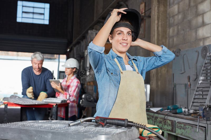 Woman as apprentice worker stock photo. Image of metal - 103873720