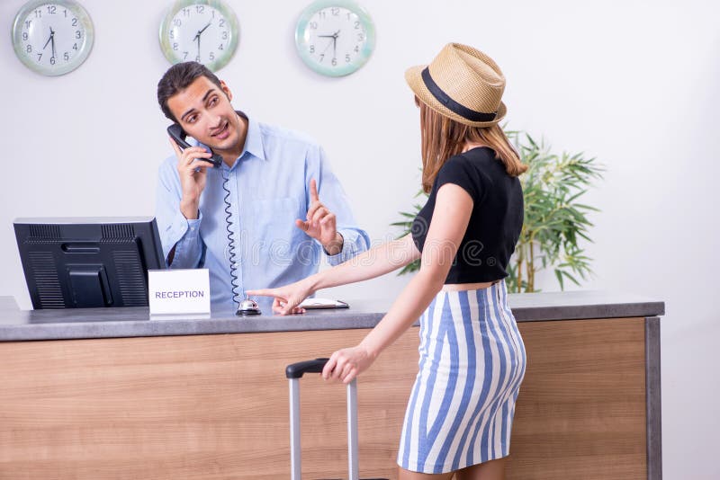 Young Woman at Hotel Reception Stock Photo - Image of discussing ...