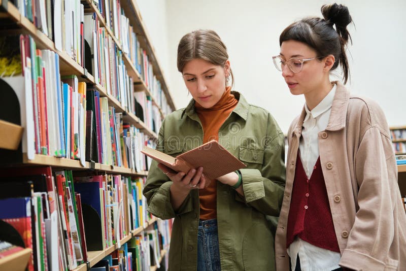 Young women in the library stock image. Image of indoors - 220264751