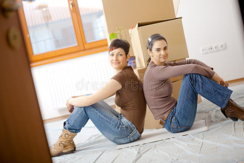 Young women moving home stock photo. Image of expression - 9628360