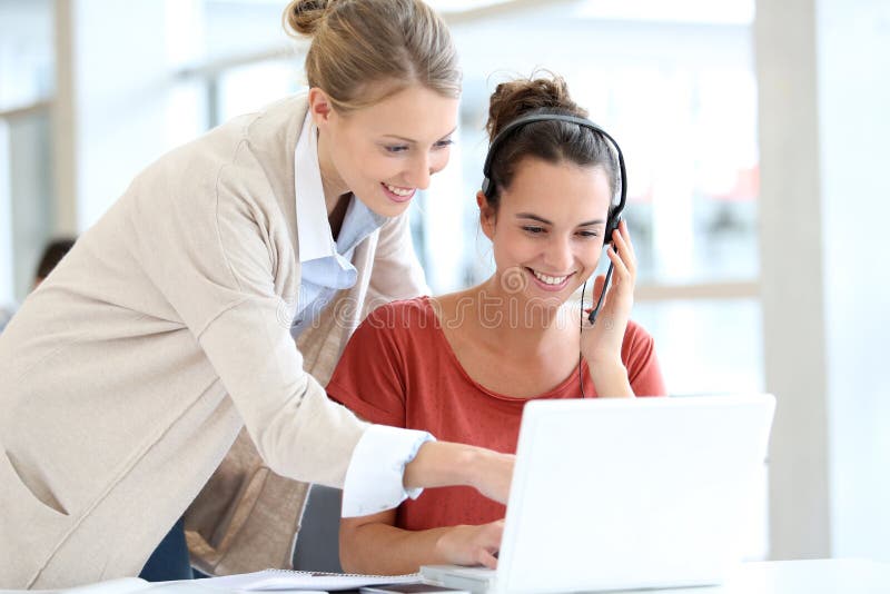 Young Women Office Workers with Headset on Laptop Stock Image - Image ...