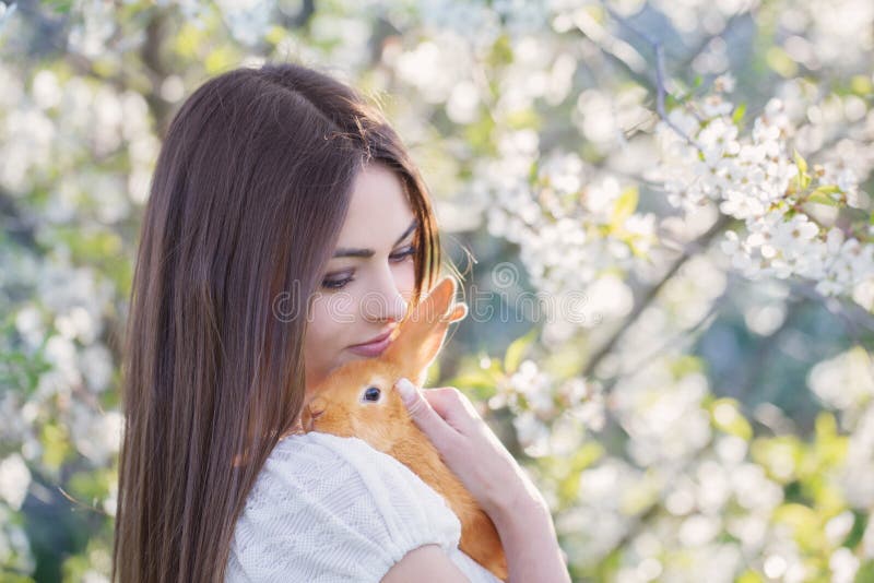 African Asian Girl Holding a Rabbit Stock Photo - Image of animal, girl ...