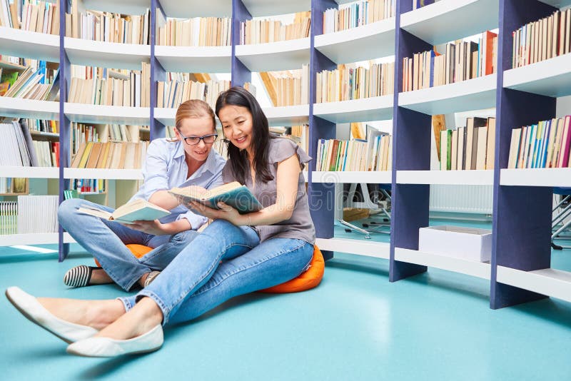 Young Women Read an Exciting Book Together Stock Photo - Image of ...