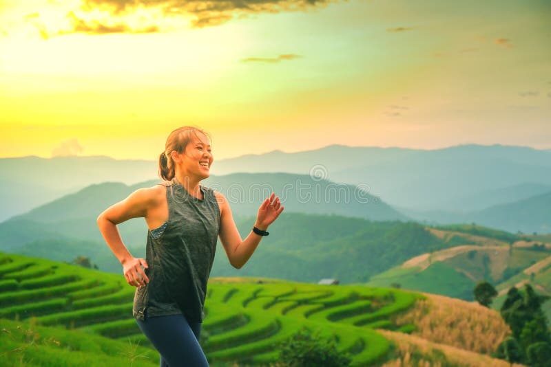 Young Women Run and Run in Fields with Mountains and Sunsets Stock ...